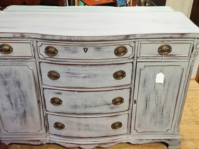 This distressed white cabinet has more character in its brass handles than most new furniture has in its entirety. Shabby chic perfection!