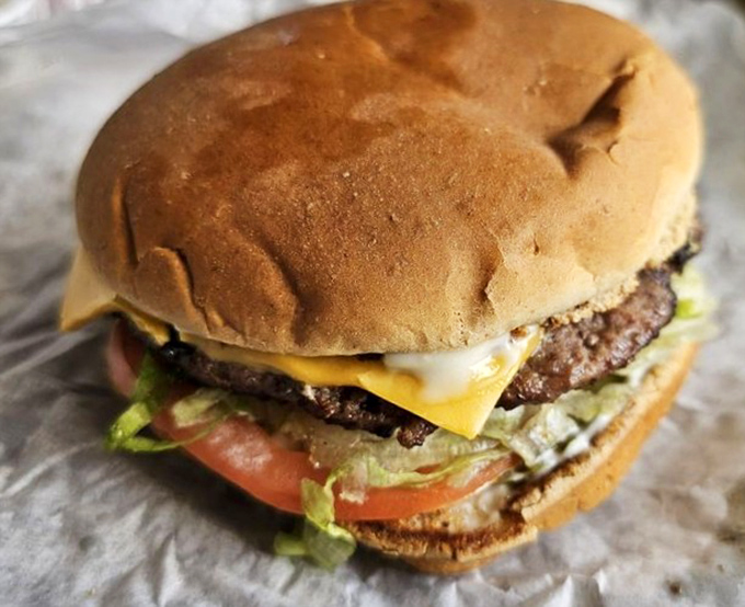 The platonic ideal of a cheeseburger&mdash;charcoal-grilled patty, melty cheese, fresh veggies, all on a toasted bun that knows its supporting role.