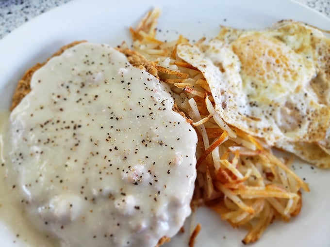 Country-fried steak smothered in peppery gravy alongside hash browns &ndash; the kind of breakfast that fuels hard work and happy naps.