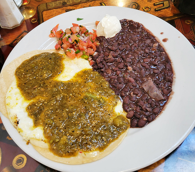 Chilaquiles that dance between comfort and adventure&mdash;where green sauce meets black beans in a breakfast fiesta worth waking up for.
