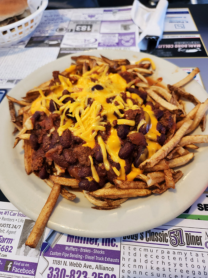 Chili cheese fries: where the line between "I shouldn't" and "I absolutely must" disappears. That golden cheese cascading over homemade chili is pure Midwestern poetry. 