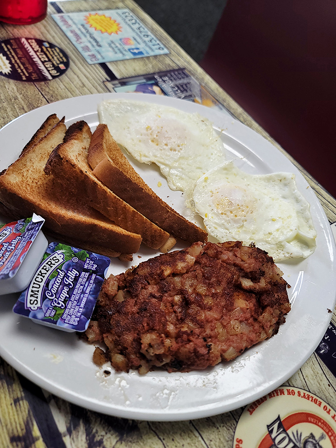 A classic diner breakfast that speaks volumes: perfectly fried corned beef hash, sunny-side-up eggs with just-right whites, and toast waiting for its moment of glory.