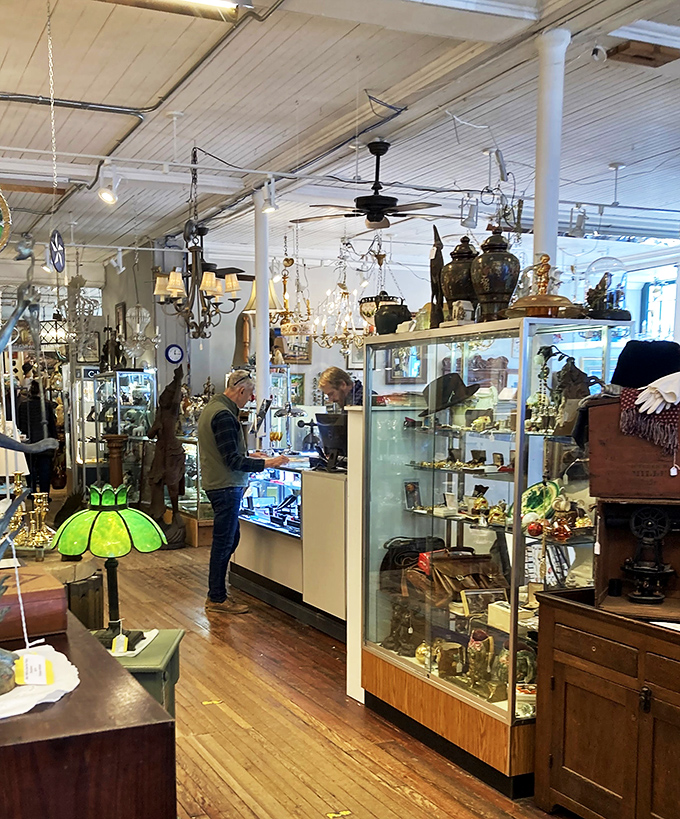 A shopper contemplates treasures in this dealer's carefully curated space. The thrill of the hunt keeps antique lovers coming back for more.