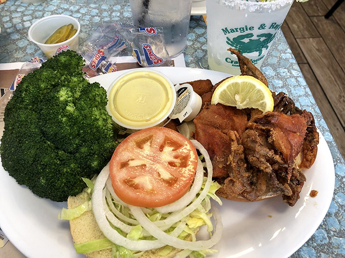 A loaded plate of fresh seafood and sides! Enjoying this fantastic meal with a signature drink. So many delicious choices here!