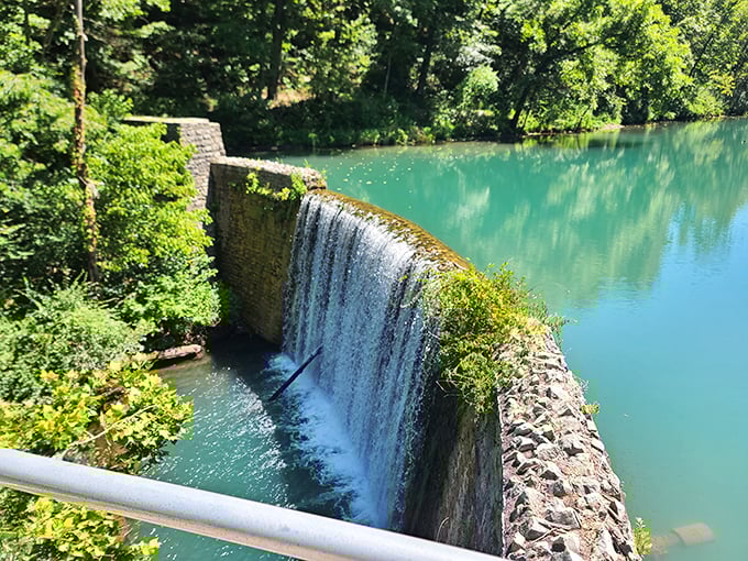 Engineering meets artistry at the dam's edge, where water transforms from calm lake to dramatic cascade in one graceful movement.