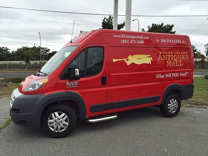 This cherry-red delivery van roams Rhode Island's streets like Santa's sleigh for antique lovers, spreading vintage joy wherever it goes.