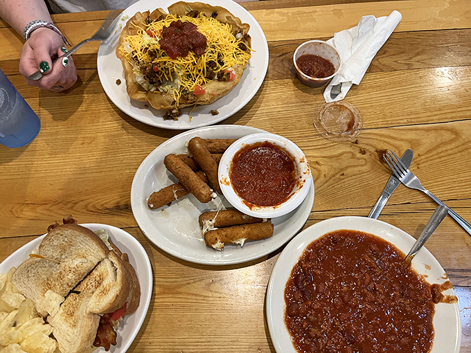 Loaded nachos and breakfast links share table space in the kind of meal that makes every day feel like Saturday.
