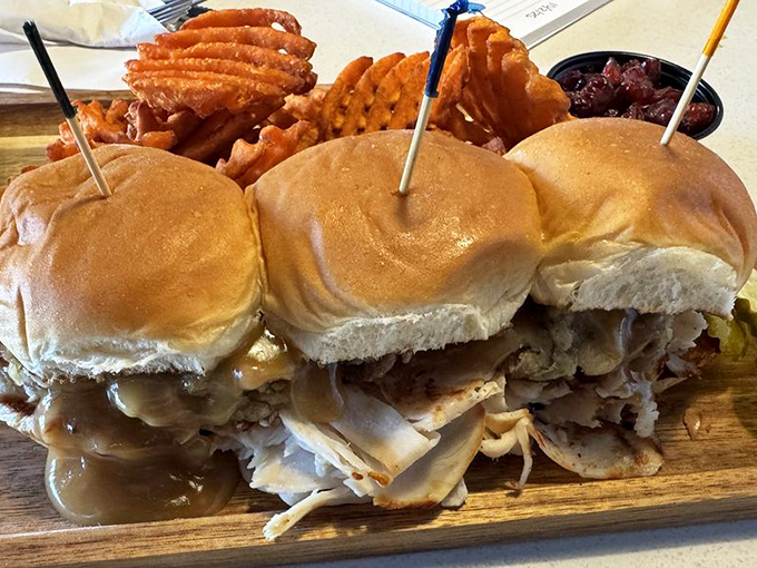 These sliders aren't just mini sandwiches; they're a trilogy of flavor with a side of waffle fries playing the perfect supporting role.