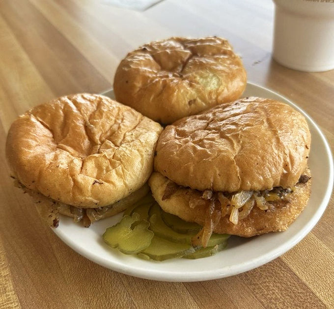 The slider trifecta&mdash;three perfectly proportioned burgers with pickles peeking out like they're playing hide and seek with your taste buds.