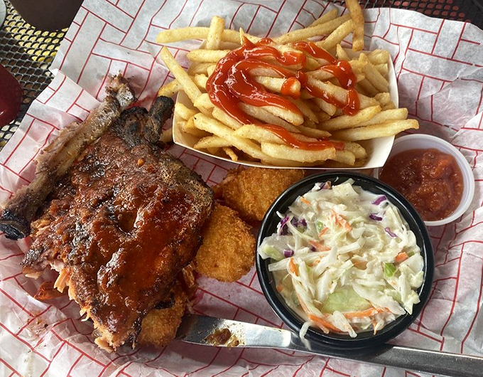 BBQ harmony on a plate. Ribs with that perfect bark, creamy slaw, golden fries, and hush puppies &ndash; a quartet that hits all the right notes.