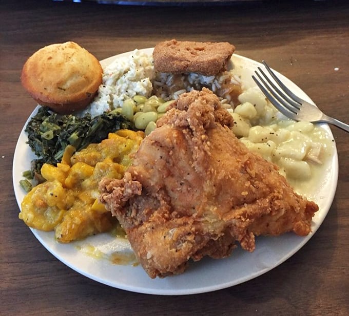 A plate that tells the story of the South in one glance: fried chicken, greens, mac and cheese, cornbread, and enough sides to feed a small militia.