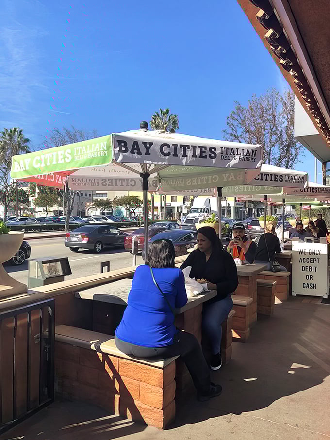 The outdoor patio at Bay Cities offers prime real estate for the main event: devouring your sandwich before you even reach the car.