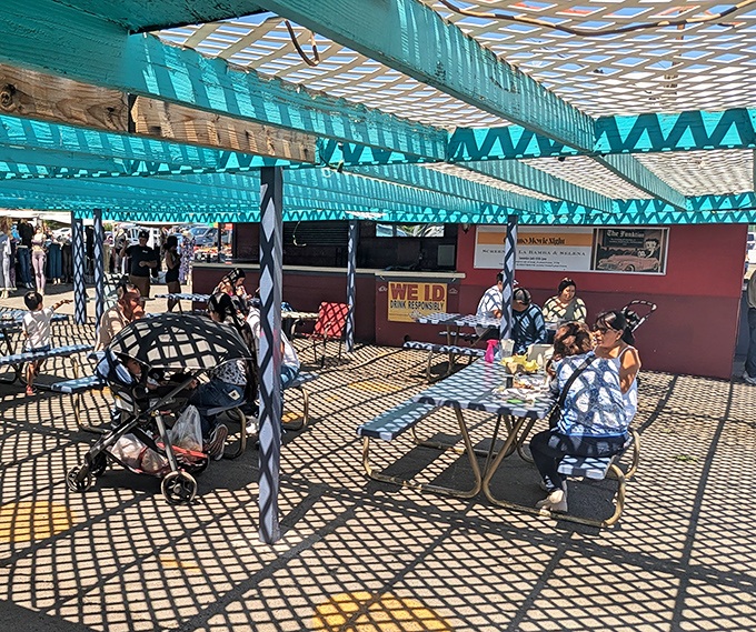 Under turquoise shade cloth, shoppers take a well-deserved break, refueling for the next round of treasure hunting.