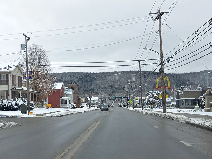 Winter transforms Coudersport's main drag into a postcard-perfect scene, with the golden arches standing sentinel against snow-capped mountains.