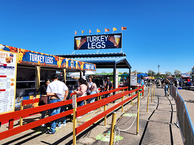 The "Turkey Legs" sign promises the kind of portable protein that requires both hands and several napkins&mdash;flea market fuel at its finest.