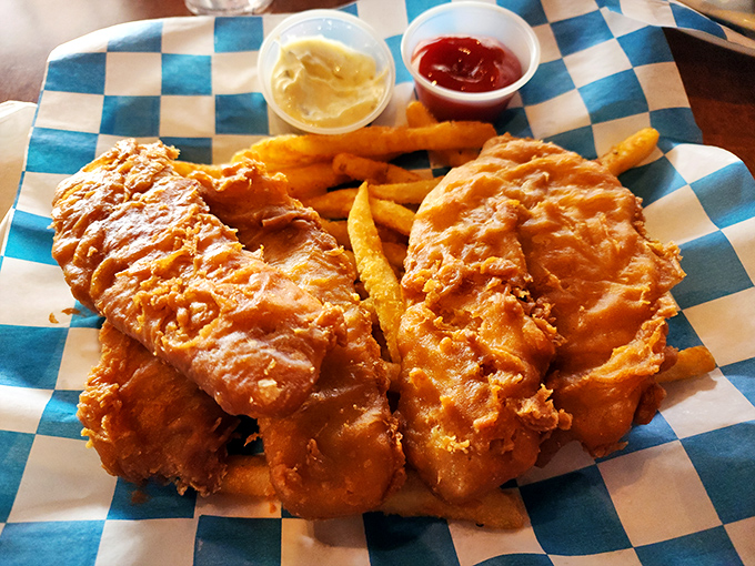 Fish and chips that would make a British pub proud. That golden batter shatters with each bite, revealing flaky white fish beneath&mdash;the ultimate comfort food passport.