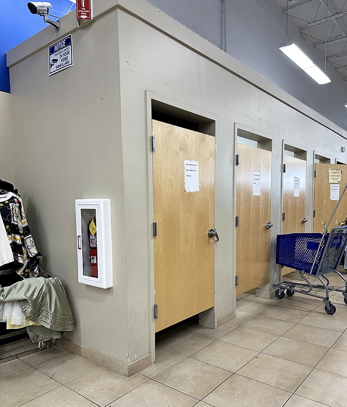 The fitting room corridor&mdash;where fashion dreams meet reality. That blue shopping cart stands ready for the "absolutely keeping this" pile.