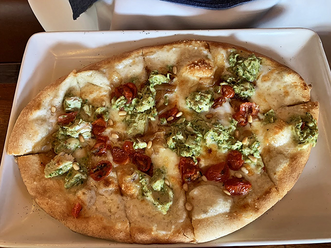 A flatbread that's achieved the perfect balance of crispy and chewy. Those sun-dried tomatoes are little flavor bombs waiting to detonate.