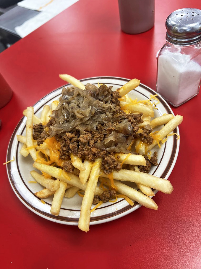 Loaded fries that don't need truffle oil or fancy aioli to impress&mdash;just cheese, seasoned meat, and caramelized onions creating a fork-worthy masterpiece.