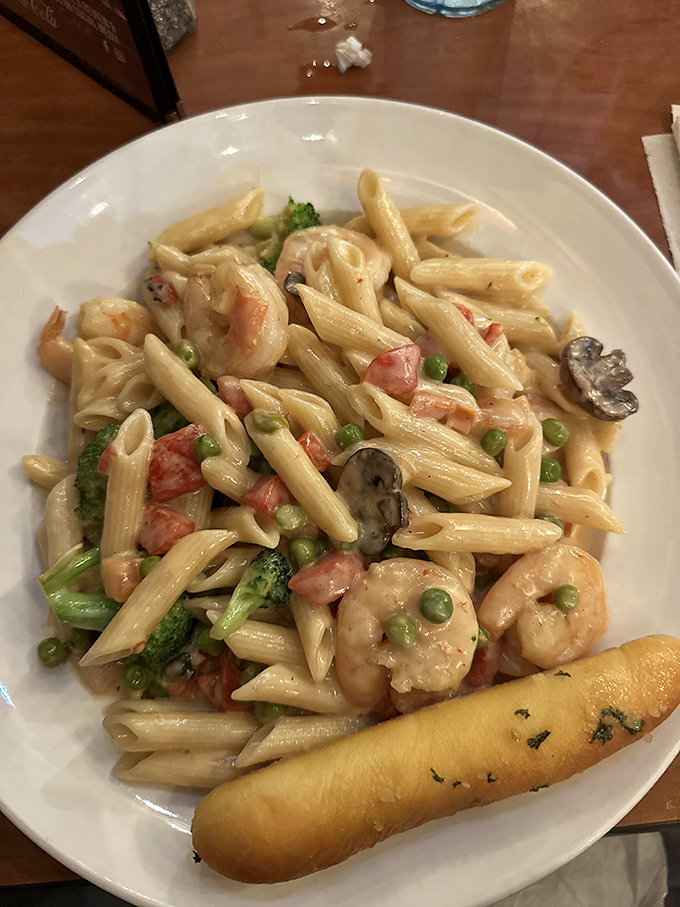 Penne primavera with plump shrimp, garden veggies, and that garlic bread sidekick&mdash;like spring and the ocean decided to throw a party on your plate.