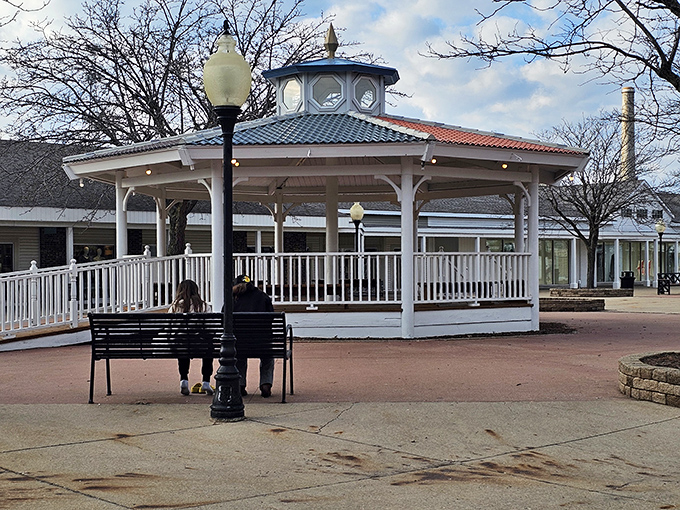 The gazebo offers a moment of Victorian charm amid shopping madness. Where exhausted partners wait while their significant others find "just one more store."