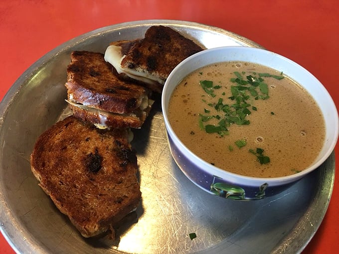 Grilled cheese and soup: the Batman and Robin of comfort food, served on a metal tray that could double as a shield in a space battle.