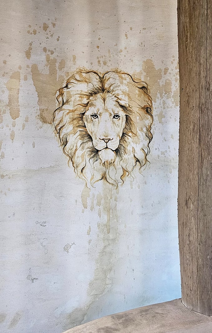 A regal lion watches over the castle interior, its weathered visage adding to the mystical atmosphere of this Florida anomaly.