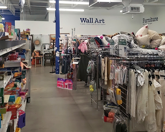 Where "Wall Art" meets "Furniture" in perfect retail harmony. The blue support columns serve as navigational beacons in this sea of secondhand treasures.