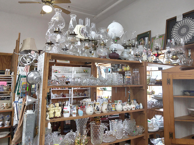A treasure trove of glassware that would make any dinner party sparkle. Each shelf holds potential heirlooms waiting for their next chapter.