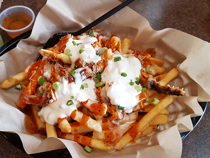 Loaded fries that blur the line between side dish and main event&mdash;a glorious mess of cheese, pulled pork, and green onions.