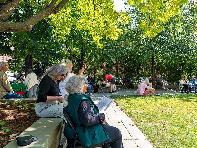 Locals enjoy a perfect Vermont afternoon in the shade – where conversations flow as naturally as the nearby Winooski River.