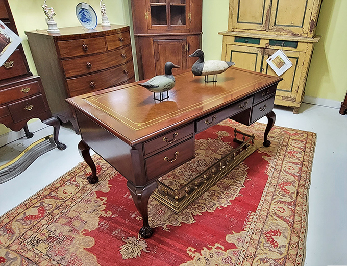 Not your average WFH setup! This mahogany Chippendale-style desk makes answering emails feel like signing the Declaration of Independence.
