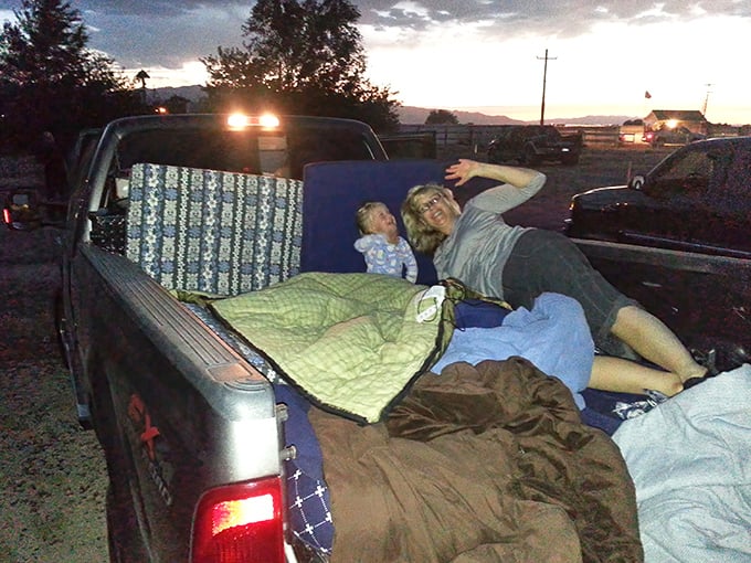 The original luxury theater seating: a pickup truck bed transformed with blankets, pillows, and the kind of comfort no recliner can match.