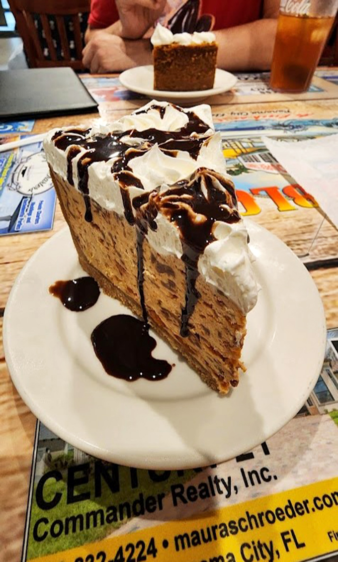A slice of peanut butter pie that makes grown adults fight over the last bite. The whipped cream and chocolate drizzle aren't just garnish&mdash;they're essential supporting characters.