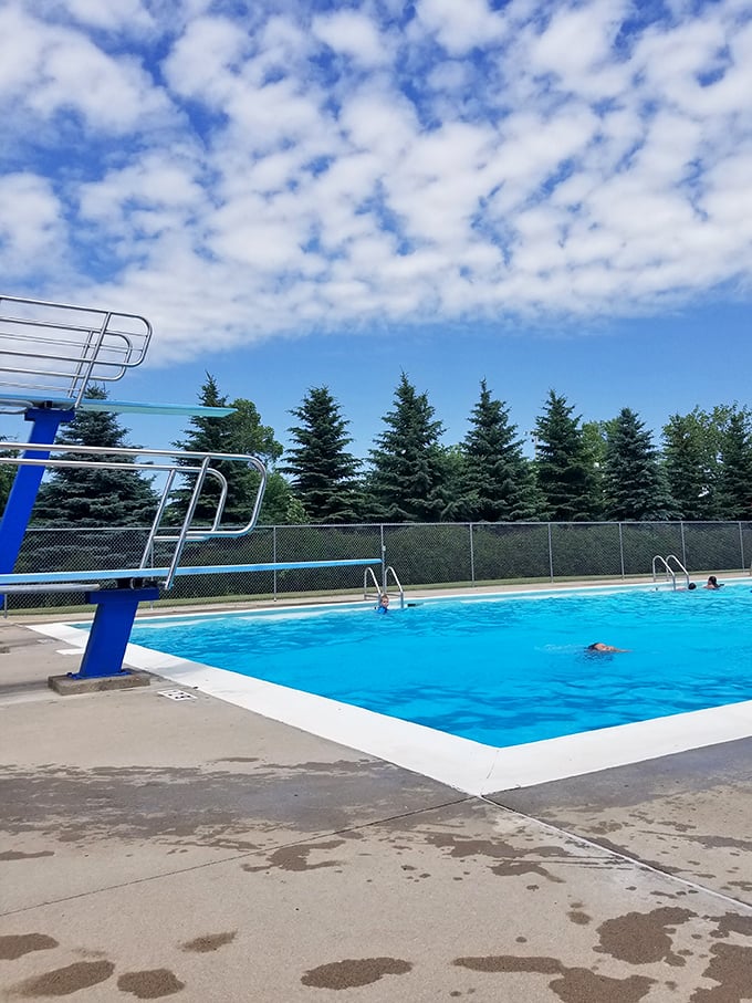 The community pool sparkles under North Dakota's endless summer sky, a refreshing oasis on hot prairie days.