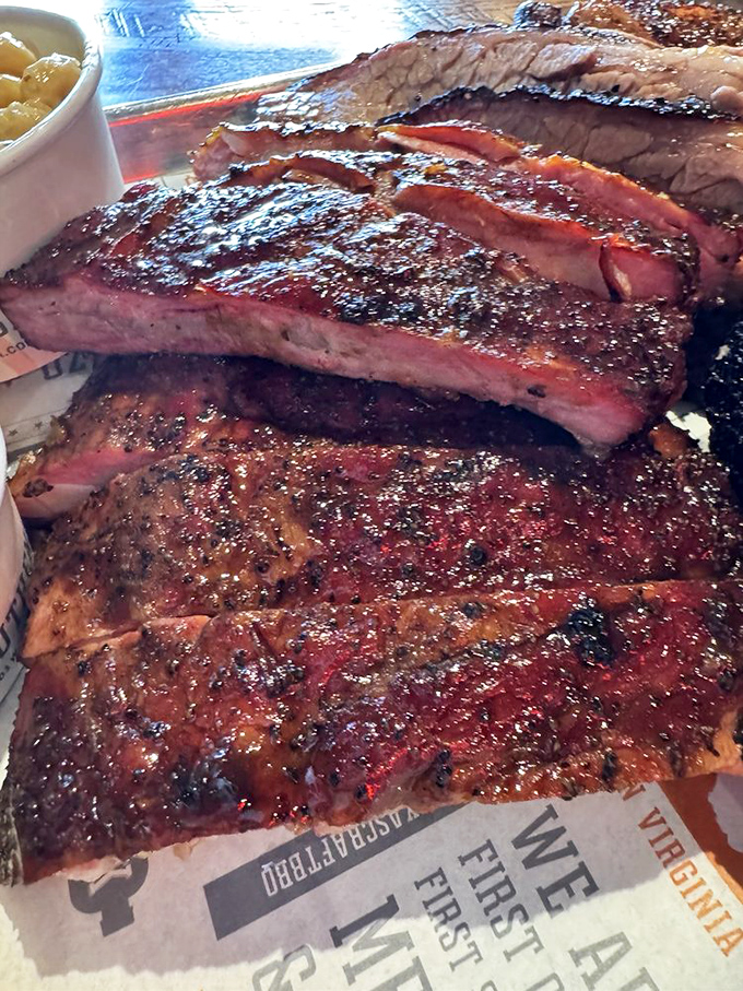 The legendary pork ribs in all its glory &ndash; perfect bark, juicy interior, and that coveted pink smoke ring that makes ZZQ famous.