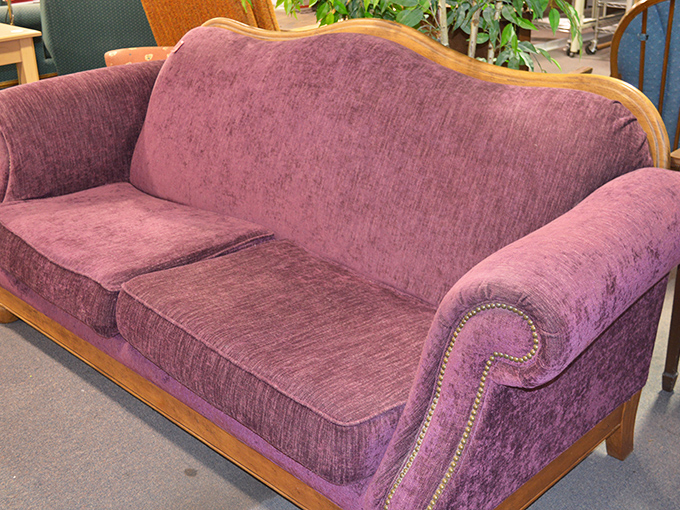 This plush purple sofa with wooden trim is just waiting to become the conversation piece in someone's living room &ndash; at a fraction of retail price.