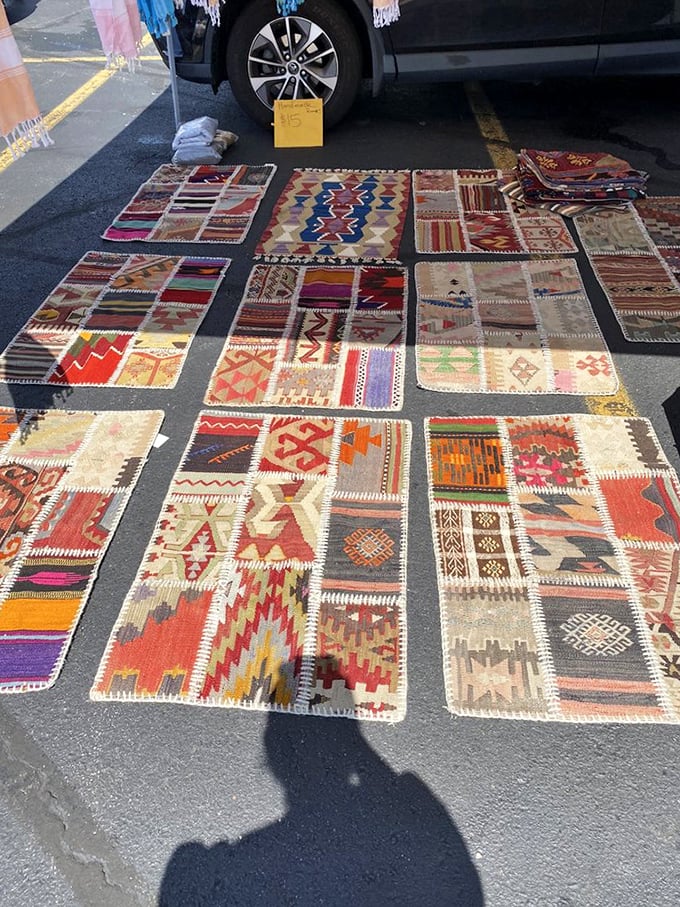 A geometric wonderland of handwoven rugs creates an impromptu art gallery on asphalt. Patterns that took months to create, available for the price of dinner.