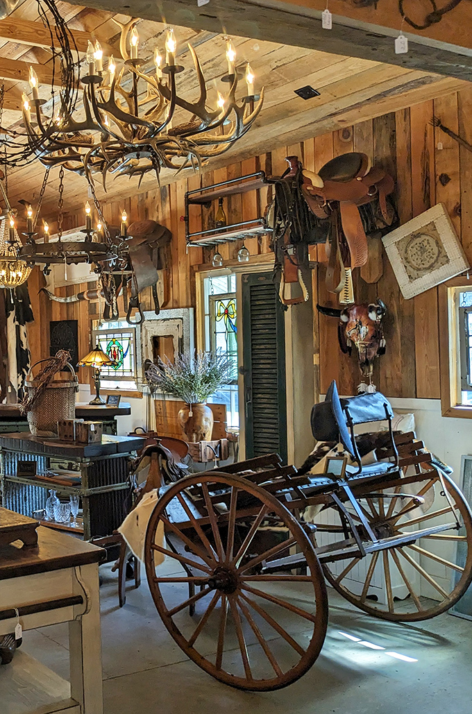 Rustic elegance meets Western charm in this dealer's space, where antler chandeliers illuminate horse tack and wagon wheels from bygone eras.