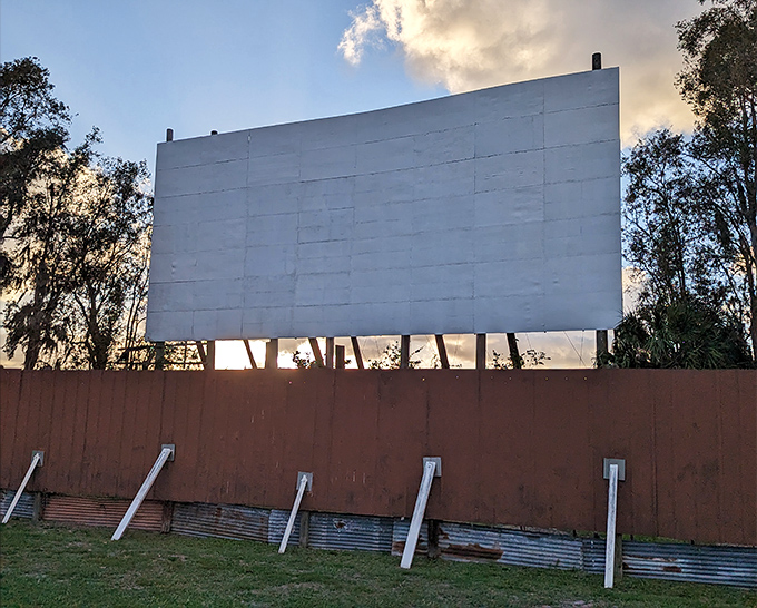 The massive screen stands sentinel against the sunset, patiently waiting for darkness to transform into a 40-foot window to other worlds.