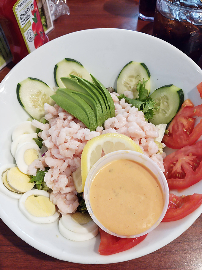 Fresh bay shrimp salad with avocado, cucumber, tomato, and egg, accompanied by house-made dressing&mdash;a lighter option that still celebrates Oregon's seafood bounty.