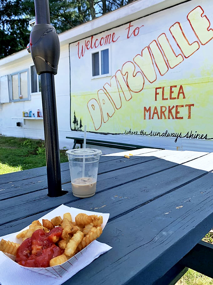 "Where the sun always shines" promises the sign, while crispy fries with ketchup deliver the universal fuel that powers serious antiquing sessions.