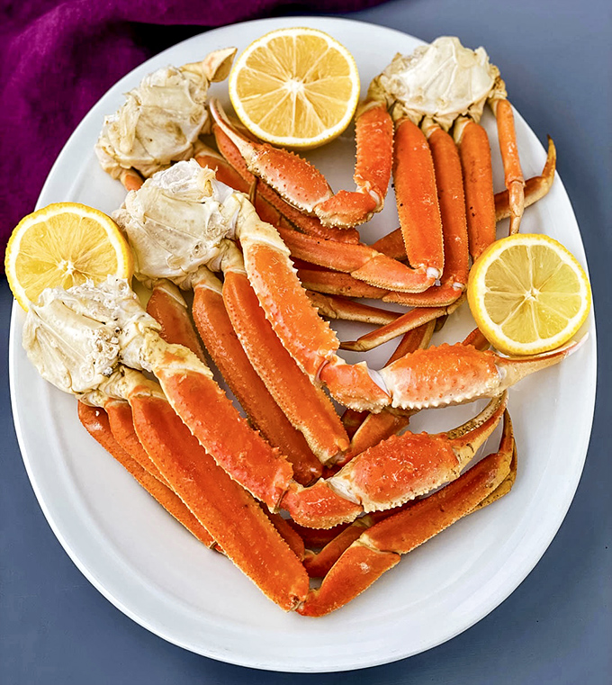 Snow crab legs arranged like nature's perfect puzzle&mdash;a seafood feast that transforms your table into coastal luxury without the oceanfront property prices.