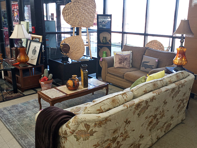 A living room tableau that whispers "come sit awhile," complete with woven baskets hanging like tropical fruit above vintage furniture.