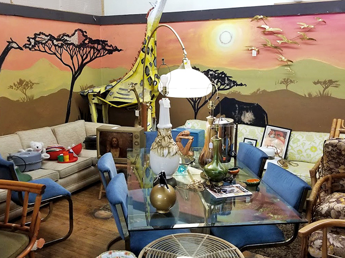 Mid-century modern meets African-inspired wall art in this eclectic furniture display that would make any HGTV designer swoon with delight.