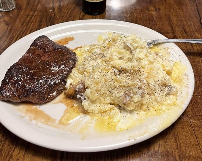 A steak and loaded potato that doesn't need fancy plating – just a sturdy plate to contain all that flavor.