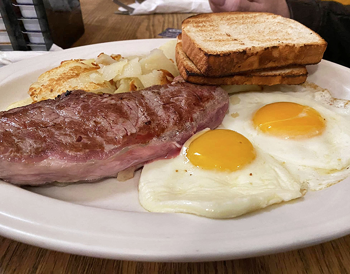 Steak and eggs: the breakfast of champions, or at least people who plan to take a serious nap later. Those sunny-side-up beauties are practically winking at you.