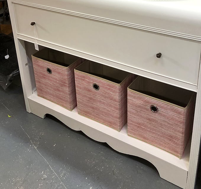 This pristine white cabinet with striped storage baskets proves that vintage shopping isn't just about dusty relics&mdash;sometimes it's about practical treasures too.