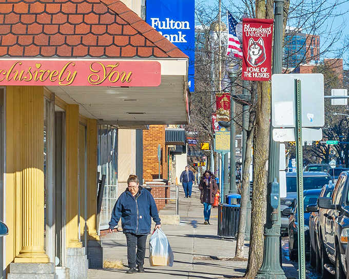 Downtown sidewalks where shopping bags don't require a second mortgage. The Huskies banner reminds you college towns keep prices student-friendly. 
