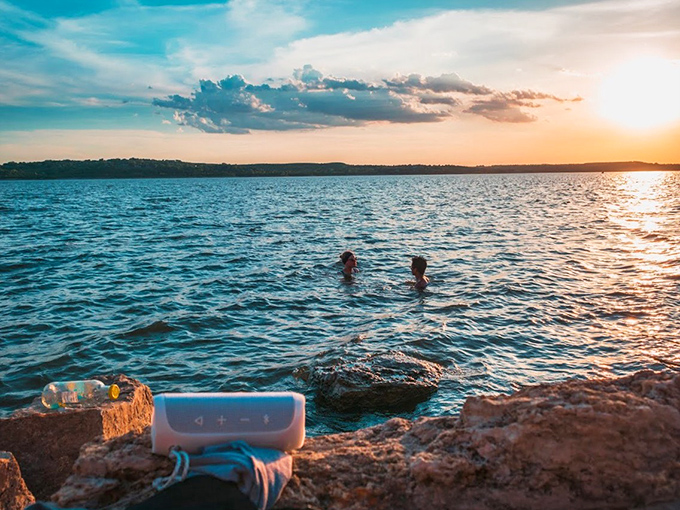 Sunset swimming at its finest, where the golden hour transforms Tuttle Creek into nature's most perfect infinity pool.